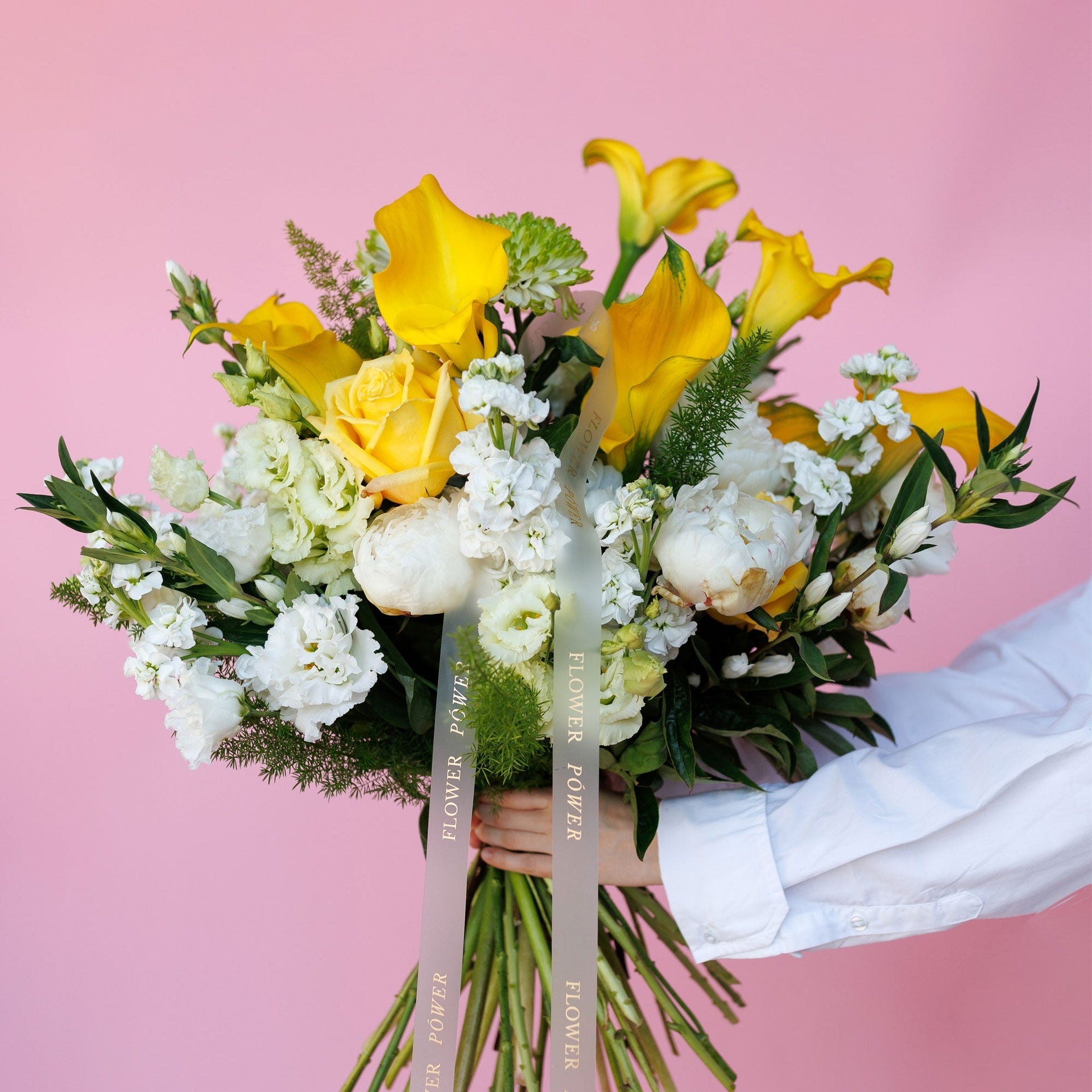 Bouquet of white eustomas, matthiolas, and peonies with yellow roses ...